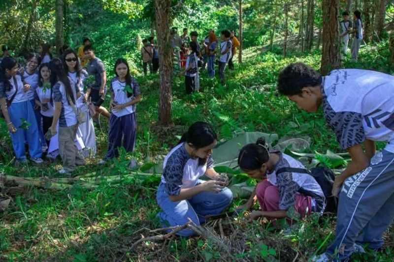 High school students, teachers, and soldiers plant trees at Camp Manuel ...